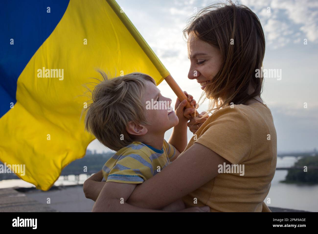 faces of a woman and a boy, mother and son, standing against the ...