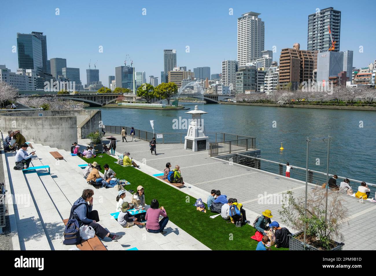 Osaka, Japan - March 29, 2023: People having a picnic on the banks of ...