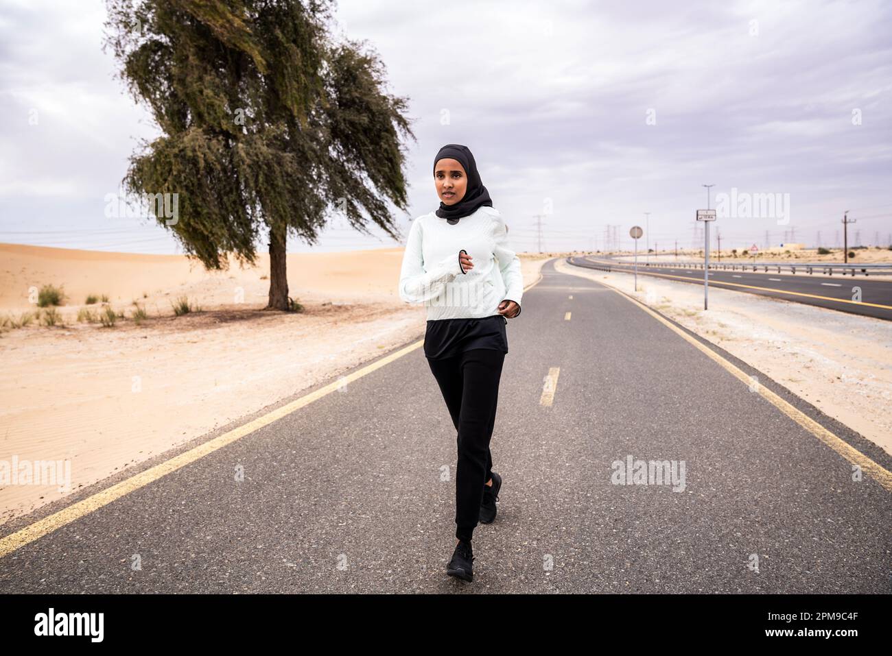 Beautiful middle-eastern arab woman wearing hijab training outdoors in ...