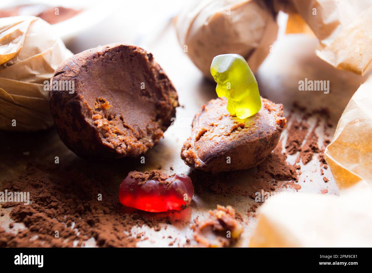 Gummy bears playing on a food table with a chocolate ball Stock Photo ...