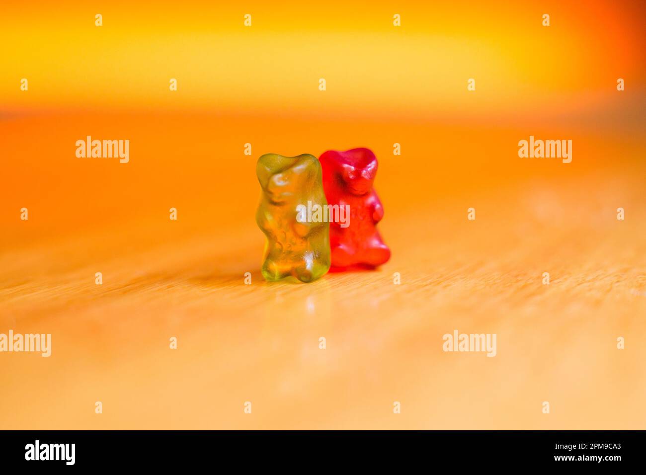 Gummy bears playing on a food table Stock Photo - Alamy