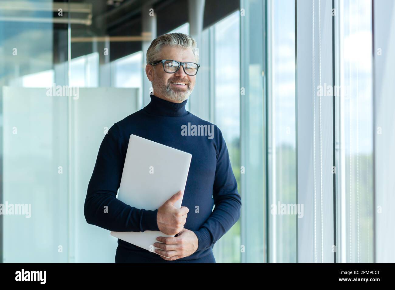 Senior architect standing window hi-res stock photography and images ...