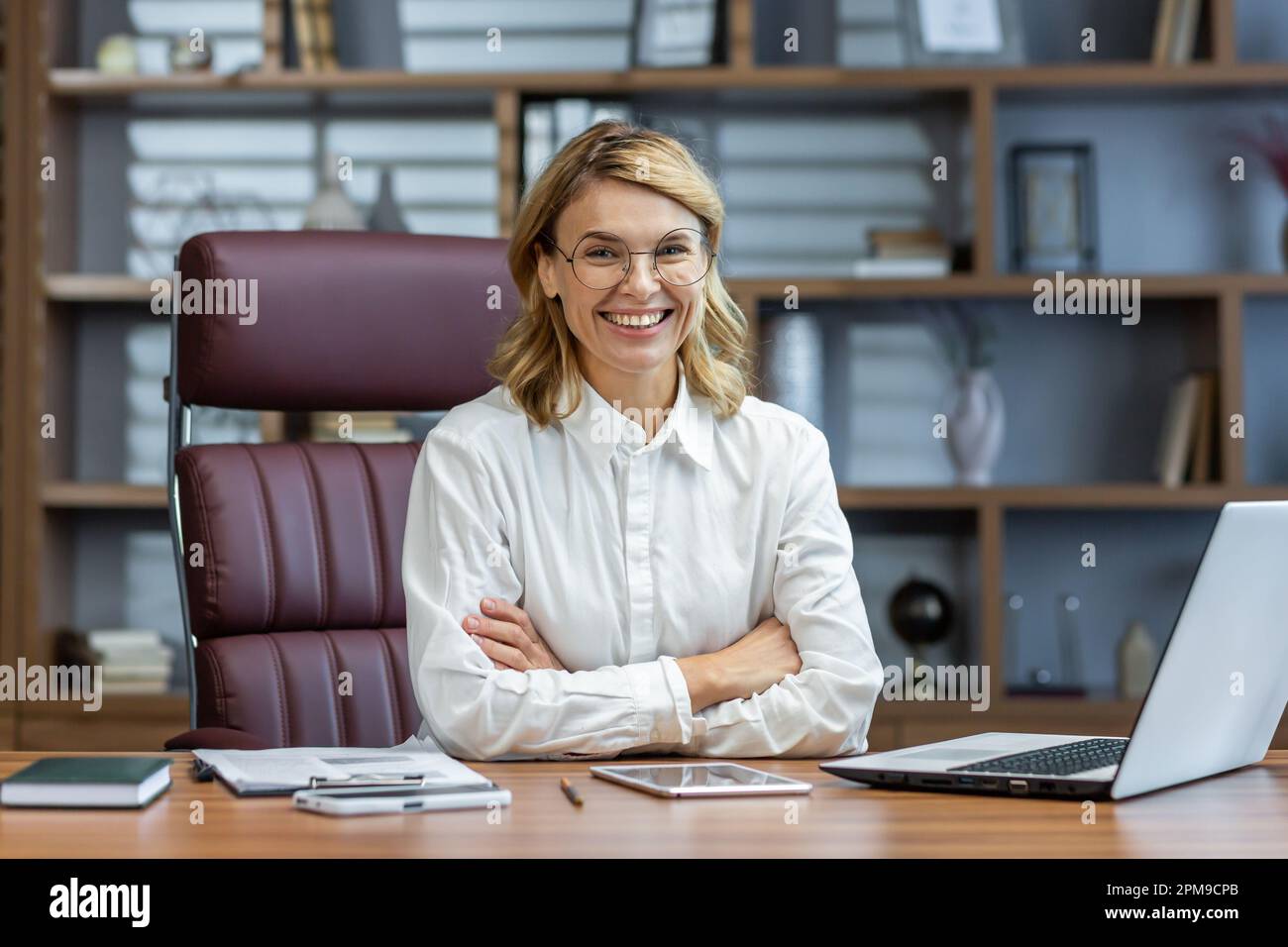Portrait of an older beautiful blonde woman, director, boss, founder of ...
