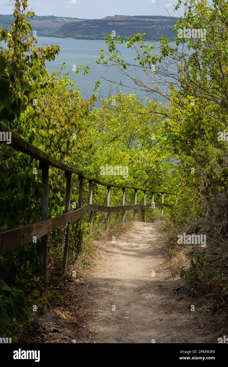 Long trail equipped with gravel steps and wooden handrail for tourists ...