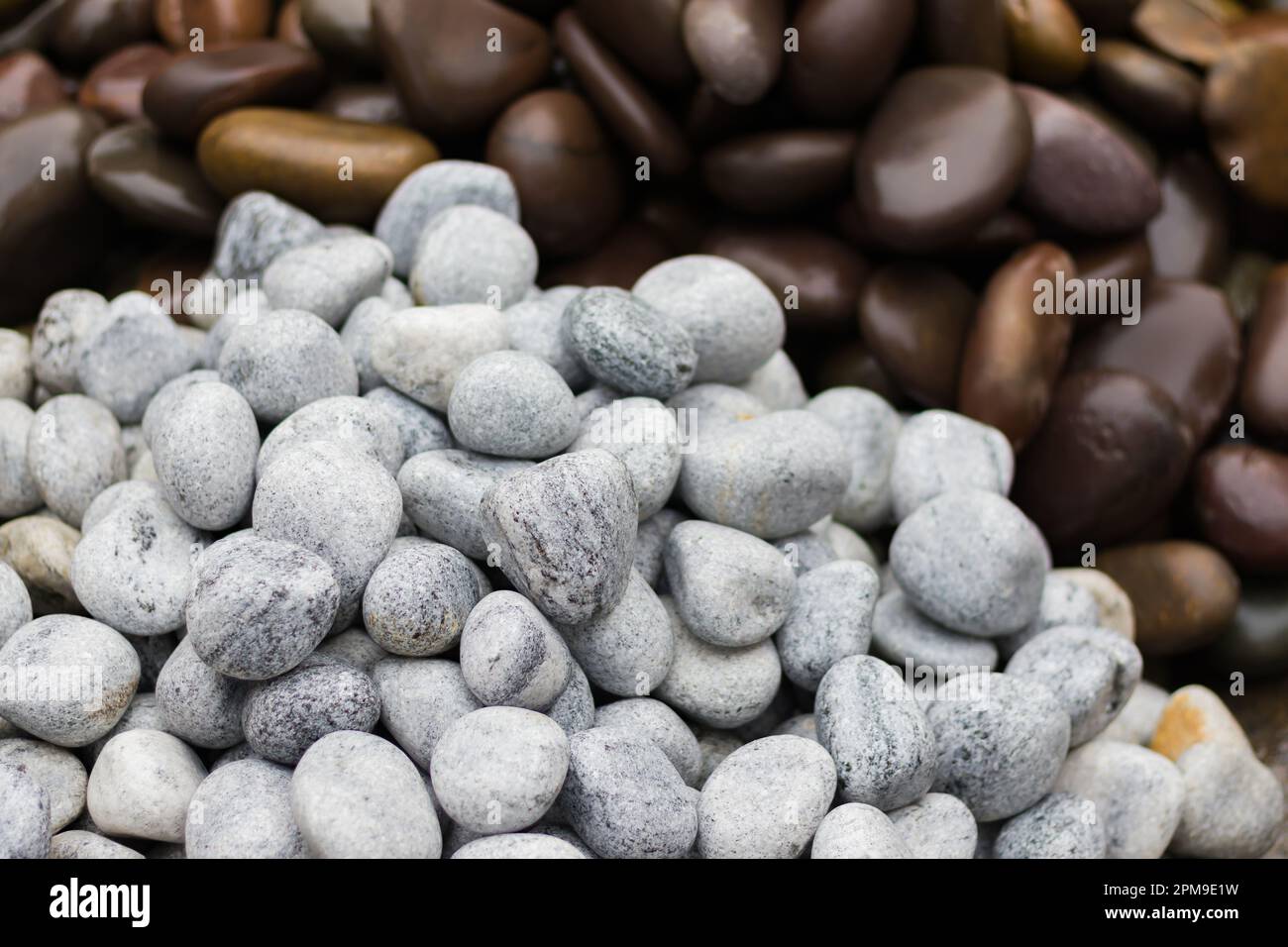 White and brown stones or pebbles of round shapes kept in piles Stock ...