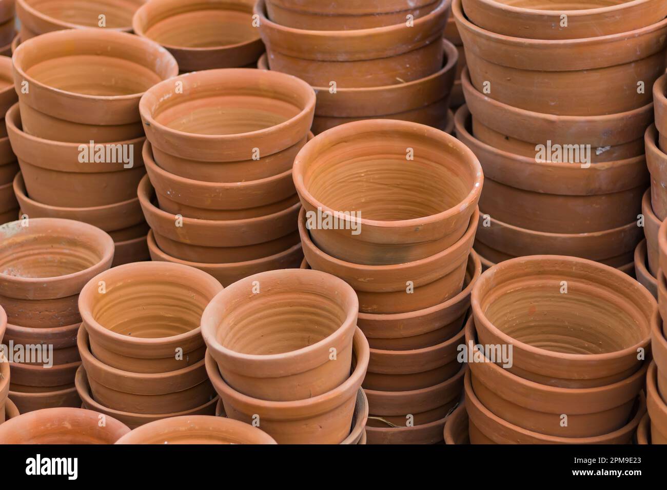 Clay pots or tubs for gardening stacked together. Terracotta pots are ...