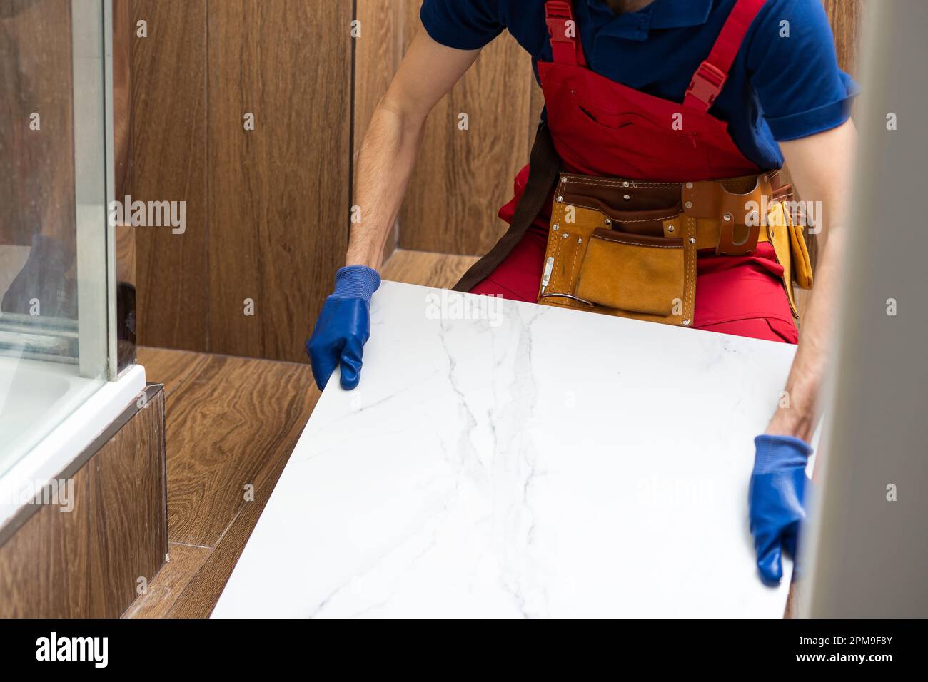 Flooring and tiling. Professional tiler placing floor tiles on adhesive ...