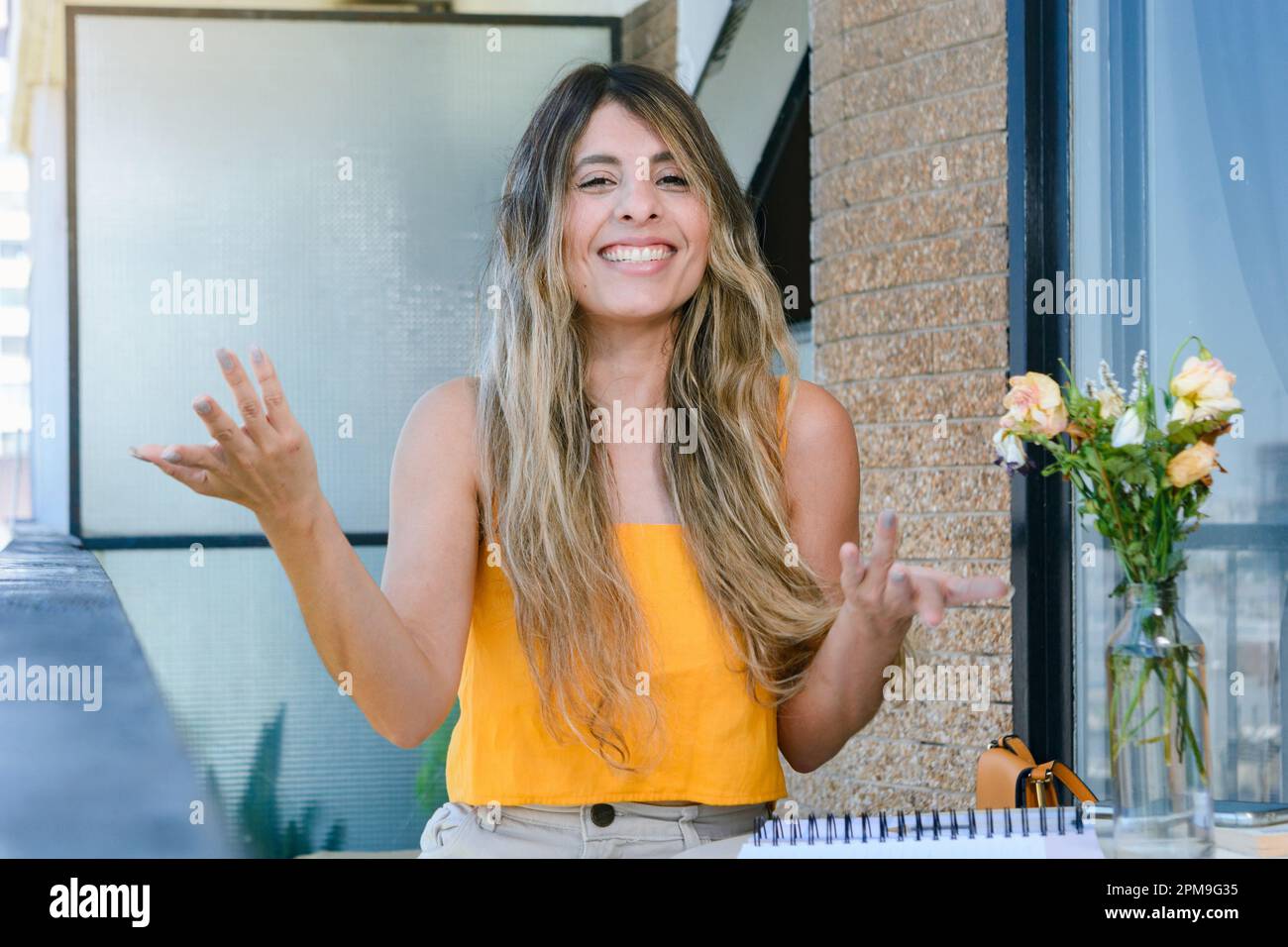 front view of young latin woman of argentinian ethnicity, sitting on ...