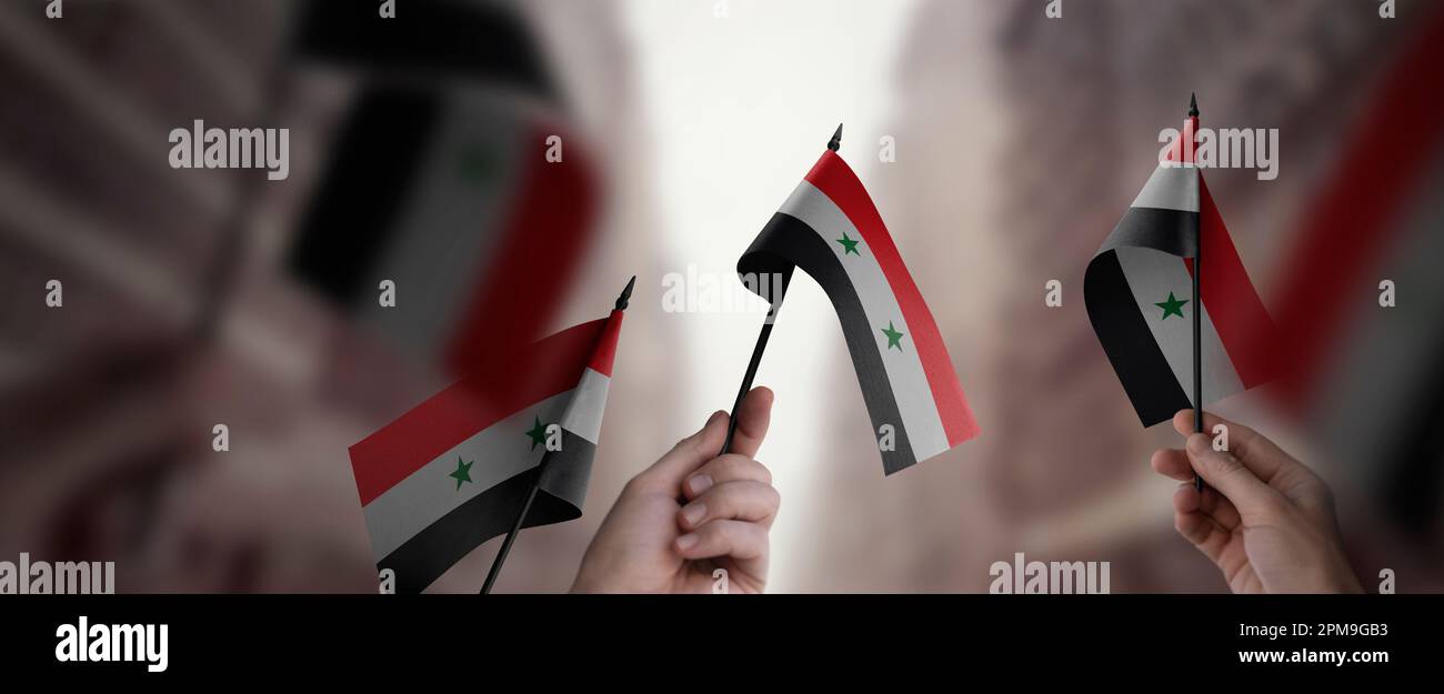 A group of people holding small flags of the Syria in their hands Stock ...