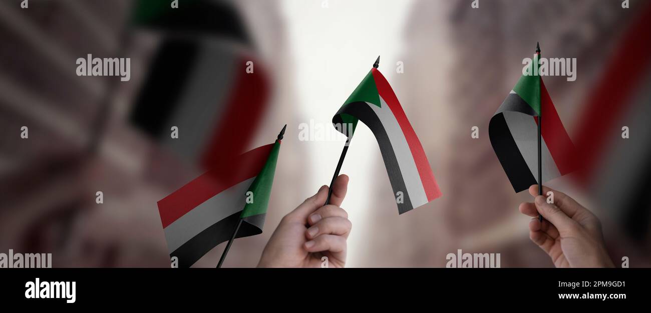 A group of people holding small flags of the Sudan in their hands Stock ...