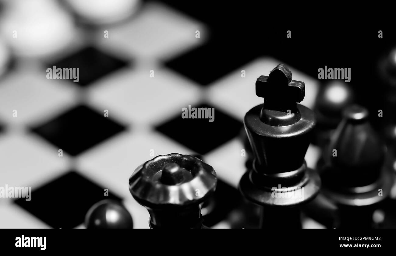 Close up of Chess pieces on a reflective mirror board surface with a ...