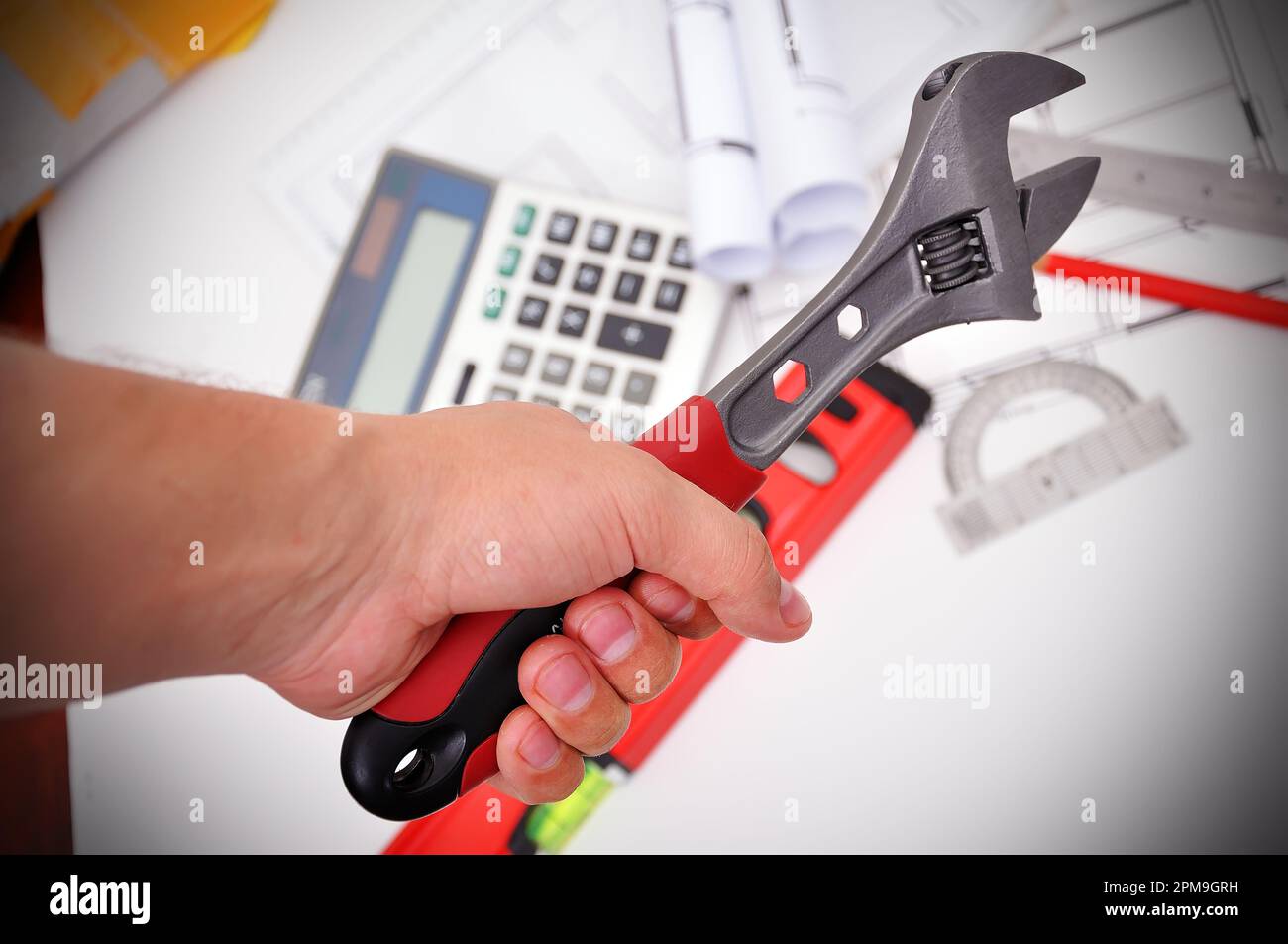 hand holding wrench and engineer tools Stock Photo - Alamy