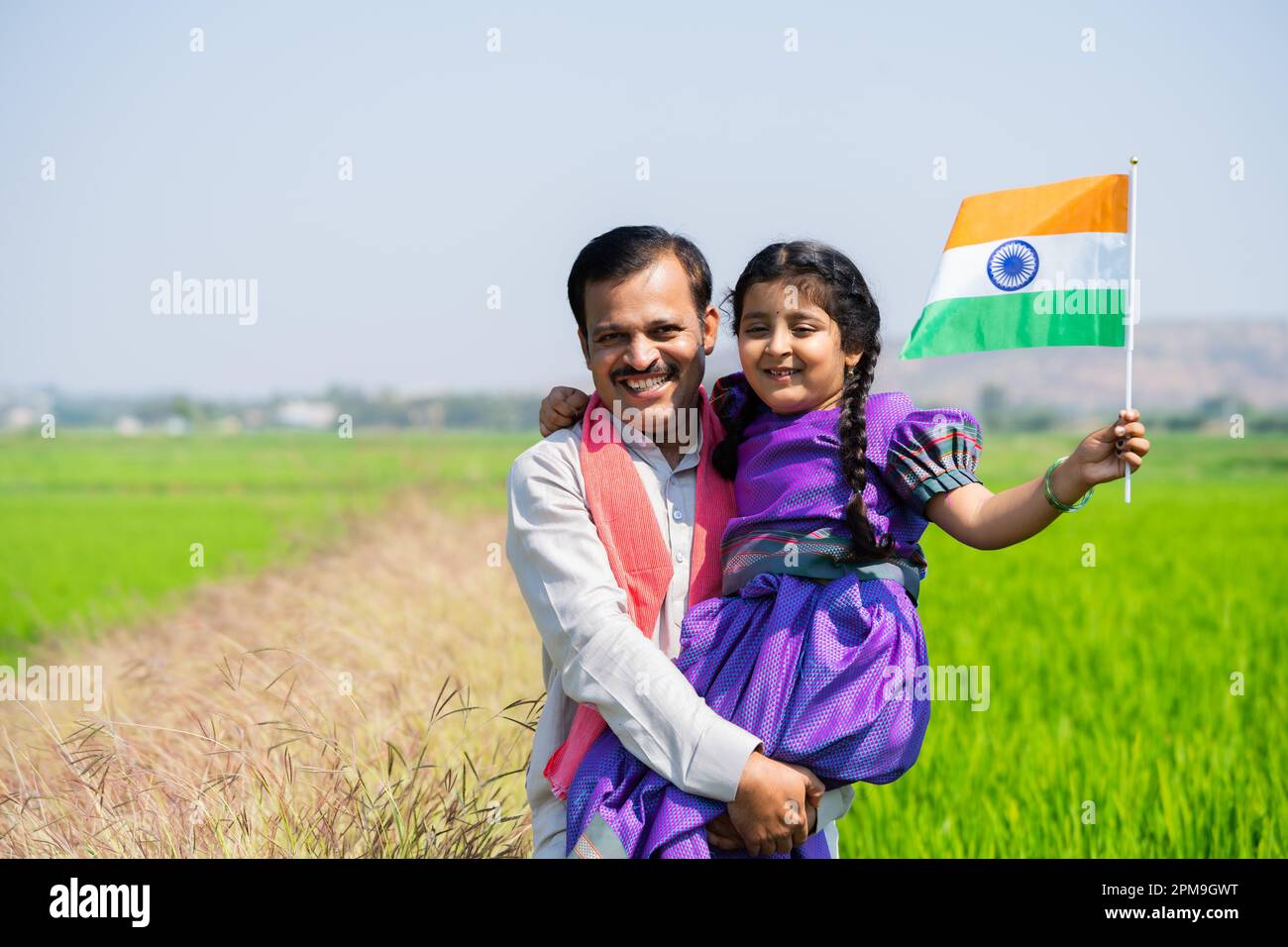 Happy Indian village father carrying daughter with indian flag by ...