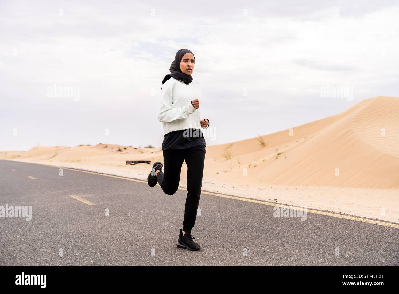 Beautiful middle-eastern arab woman wearing hijab training outdoors in ...