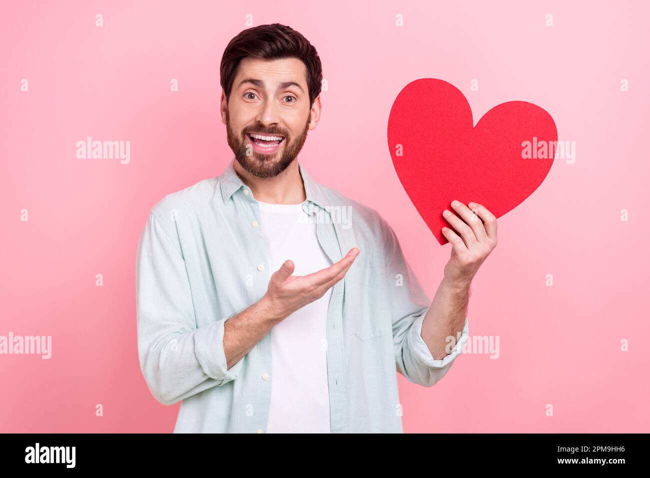 Photo of young funky excited boyfriend showing his sympathy hold paper ...