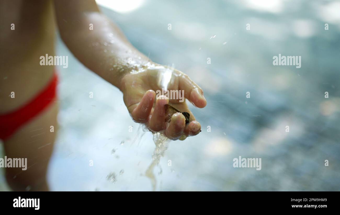 Small child washing hands outside in public water park. Kid hand ...