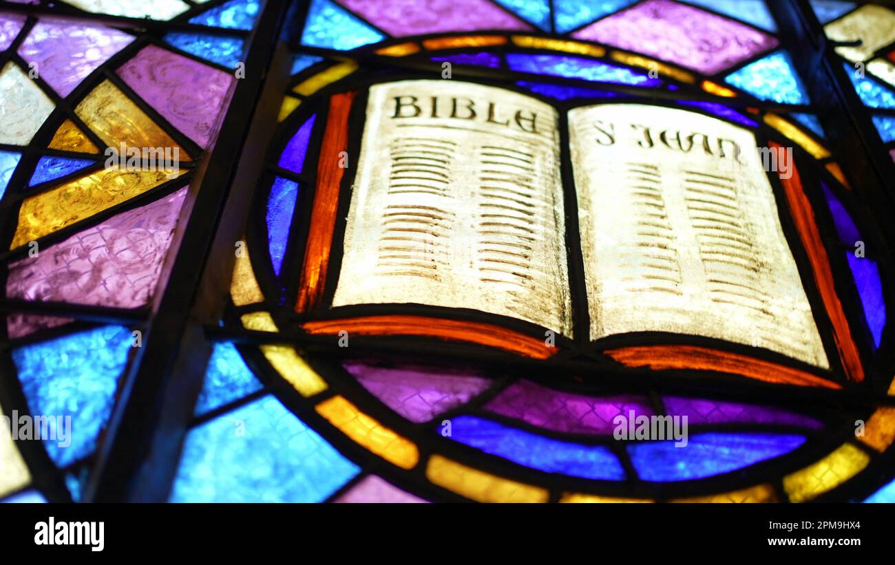 Stained Catholic Church glass with image of the Bible Scriptured inside ...