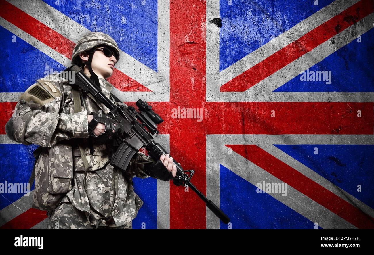 soldier holding rifle on a England flag background Stock Photo - Alamy