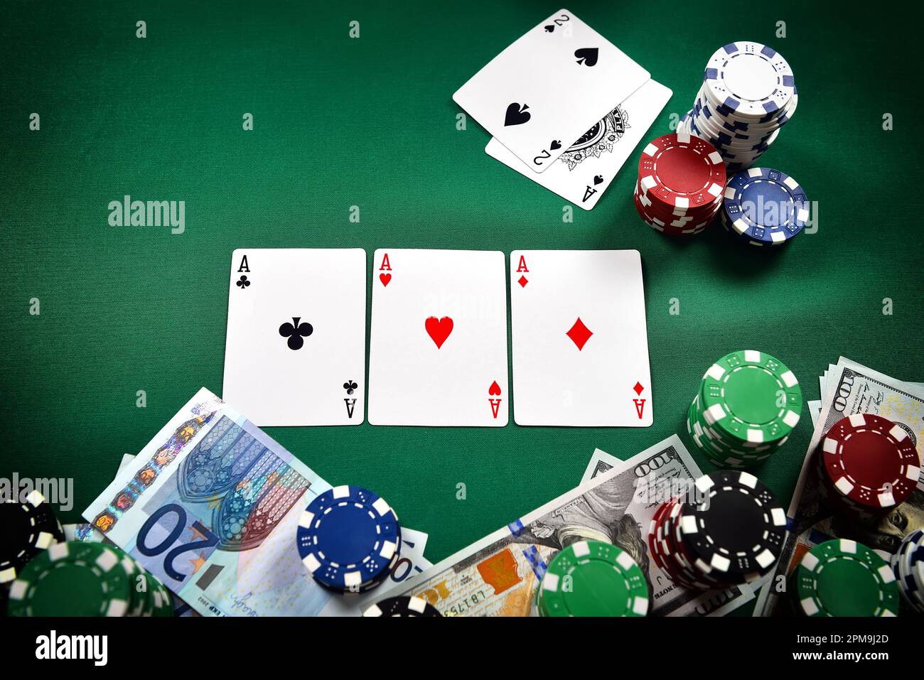 chips and three aces on green table, poker game concept Stock Photo - Alamy