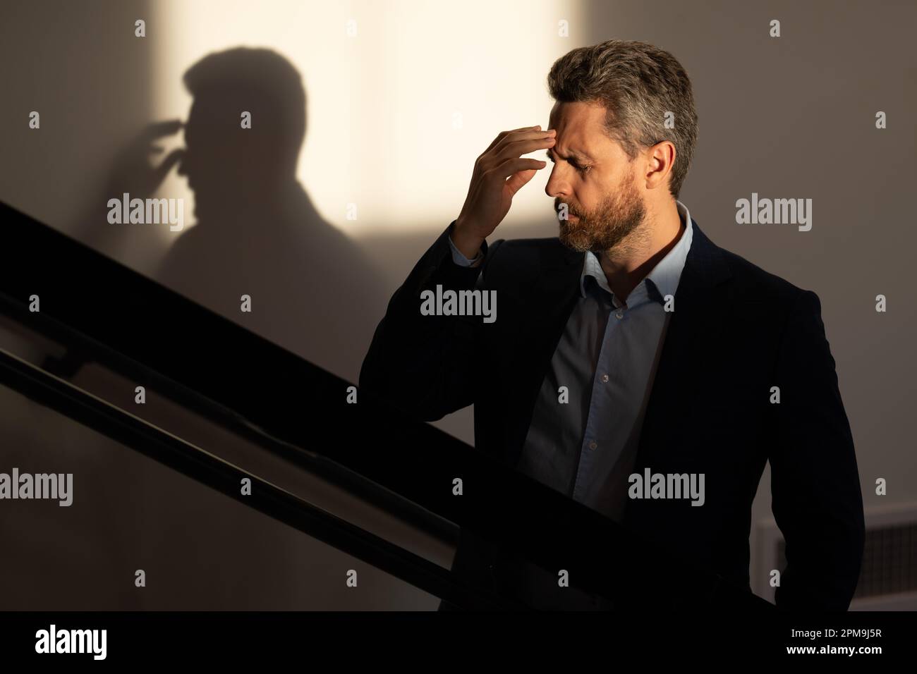 Tired exhausted man suffering from headache. Overworked burnout man ...