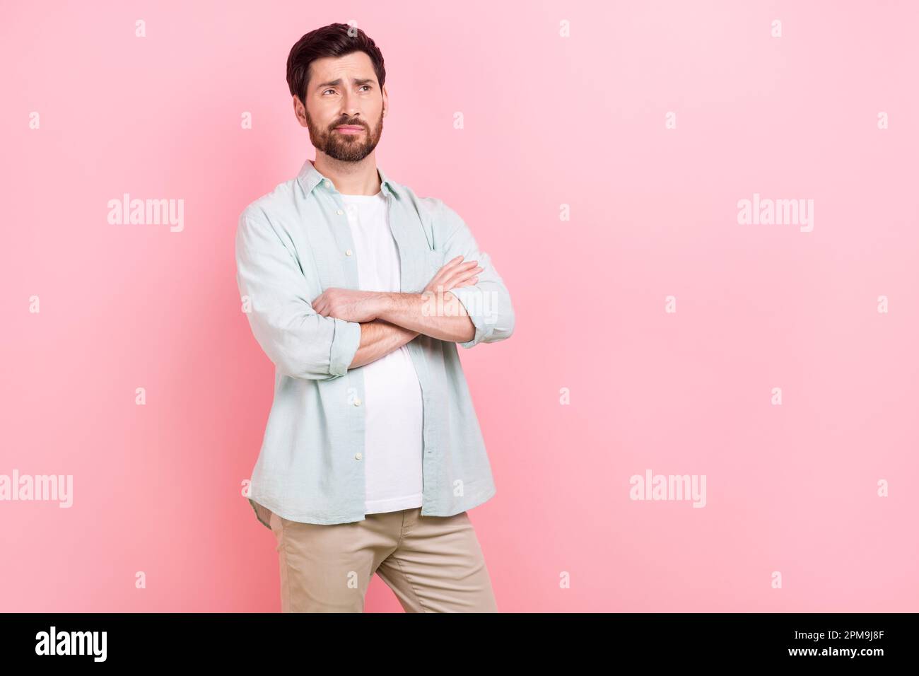 Photo portrait of nice young male crossed arms look skeptical empty ...