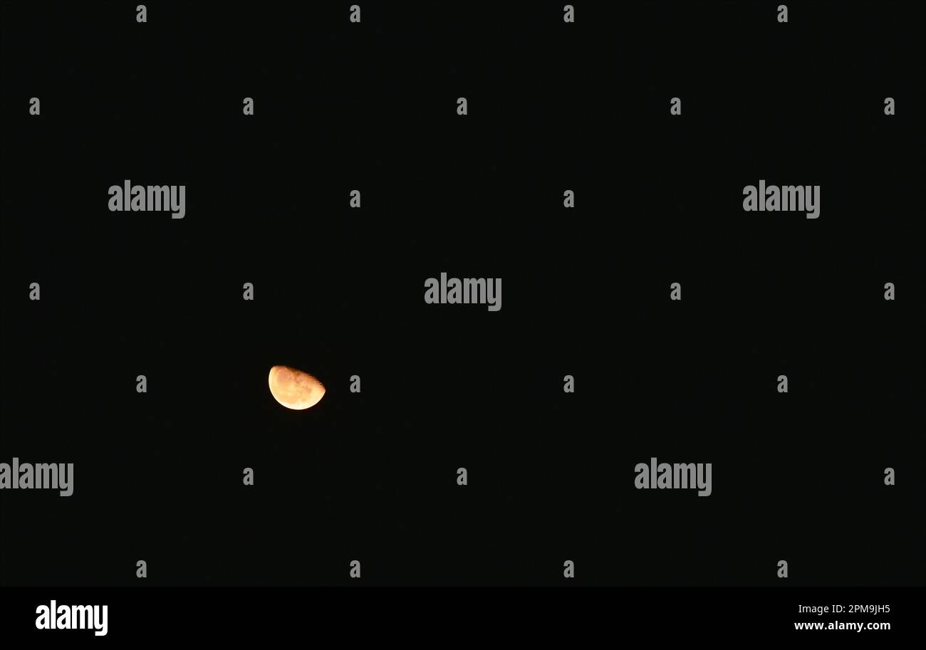 half yellow moon floating on sky in night background Stock Photo - Alamy