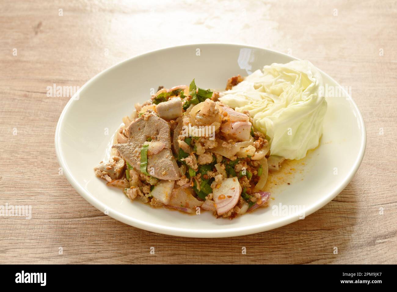 Thai spicy chop pork and slice skin salad with fresh vegetable on plate ...