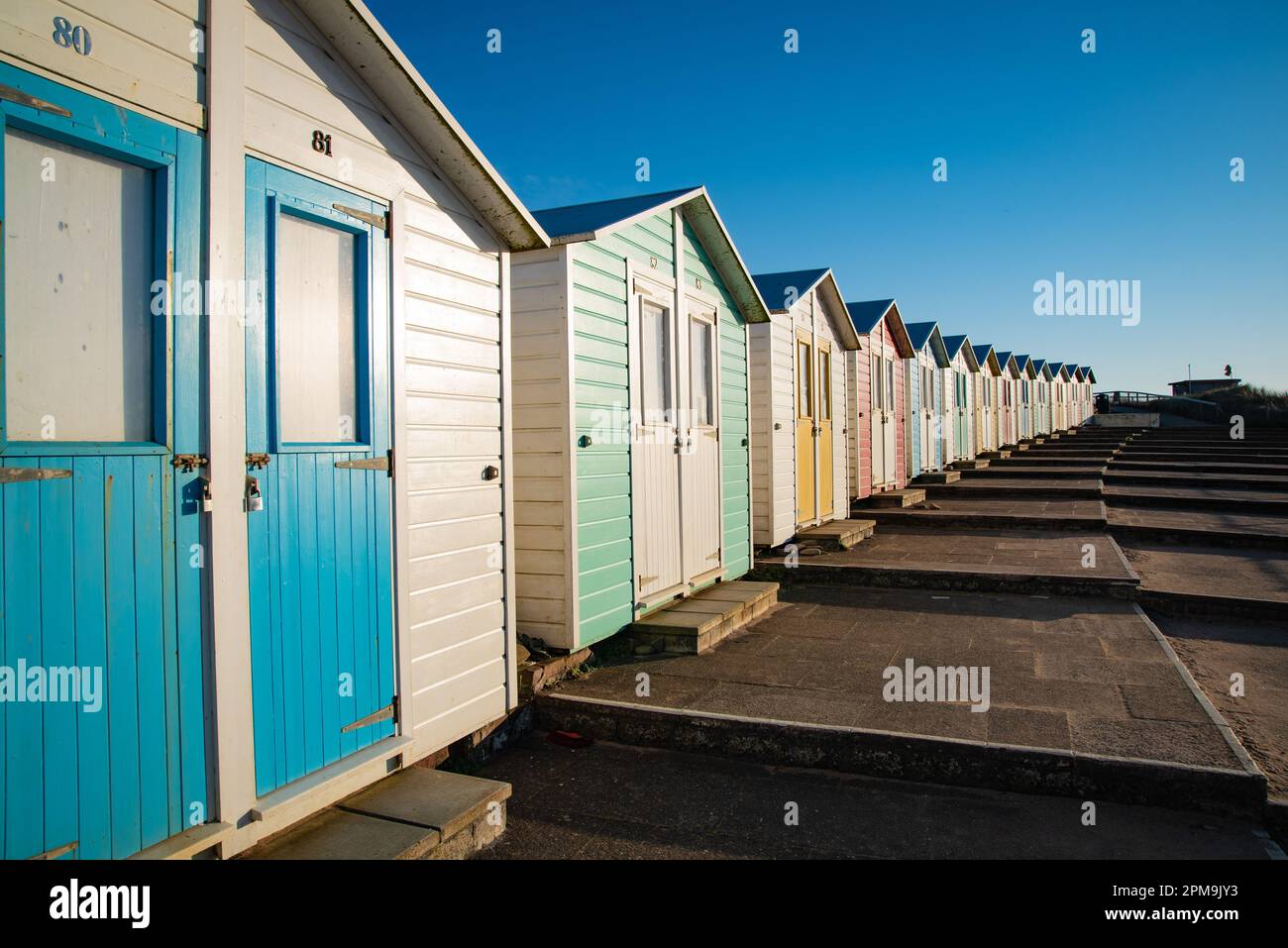 Colourful beach huts at English beach Stock Photo - Alamy