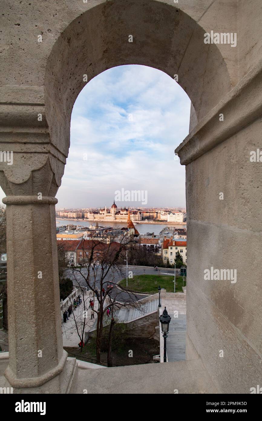 view through a round arch to the hungarian parliament building at the ...
