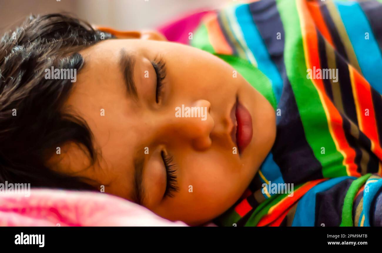 A portrait of an Indian boy sleeping / napping Stock Photo - Alamy