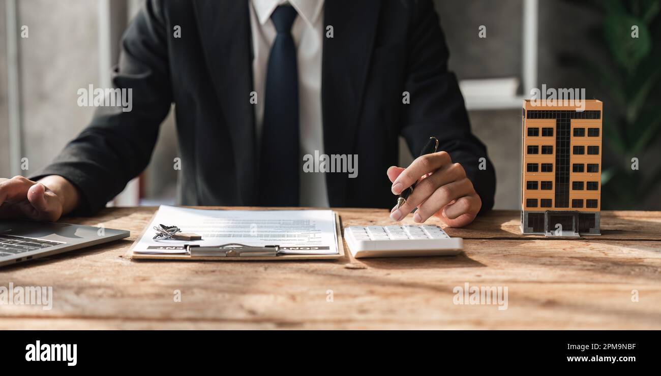 Bank loan workers are using calculators to calculate home loan interest ...