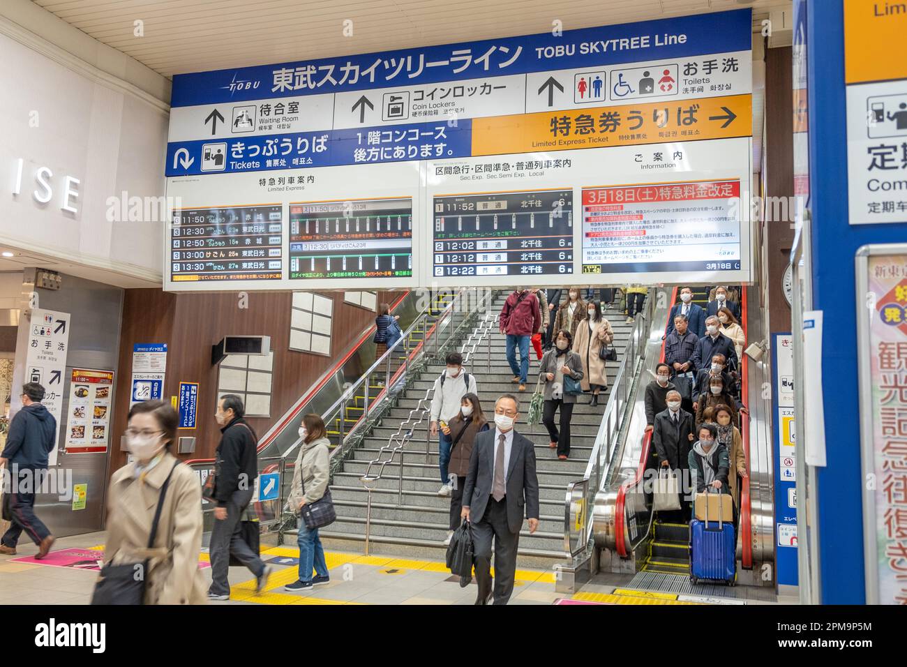 Tokyo, Japan - March 17, 2023: people at Tokyo subway station. Signage ...