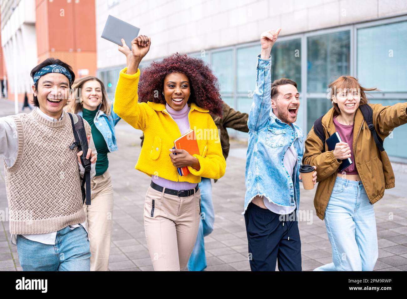 young students celebrate on the street the end of school exams ...