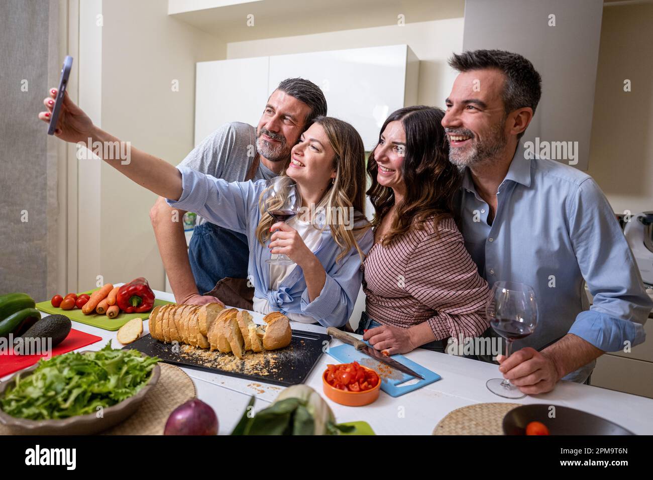 Group of people celebrating vegan party at home, making photos and ...
