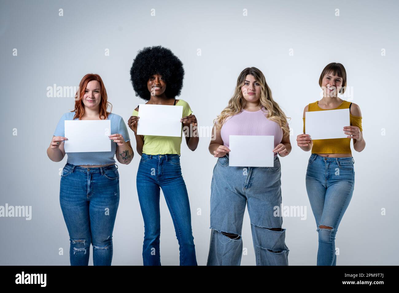 Women holding blank white board over chest, body positive concept, copy ...