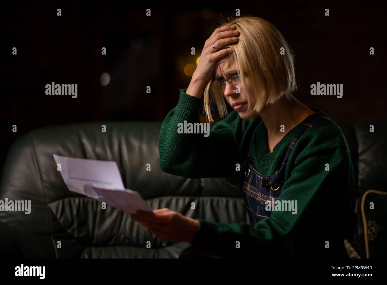 the woman received a shocking letter. Bad news, debt, bad news. Middle ...