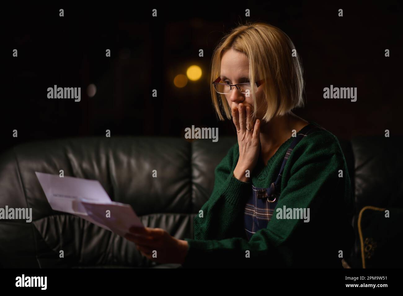 the woman received a shocking letter. Bad news, debt, bad news. Middle ...