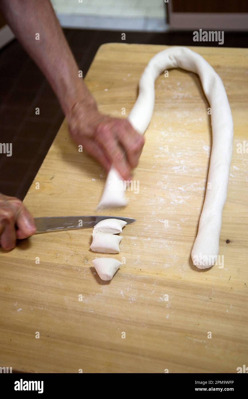 anonymous female preparing dough for homemade gnocchetti pasta ...