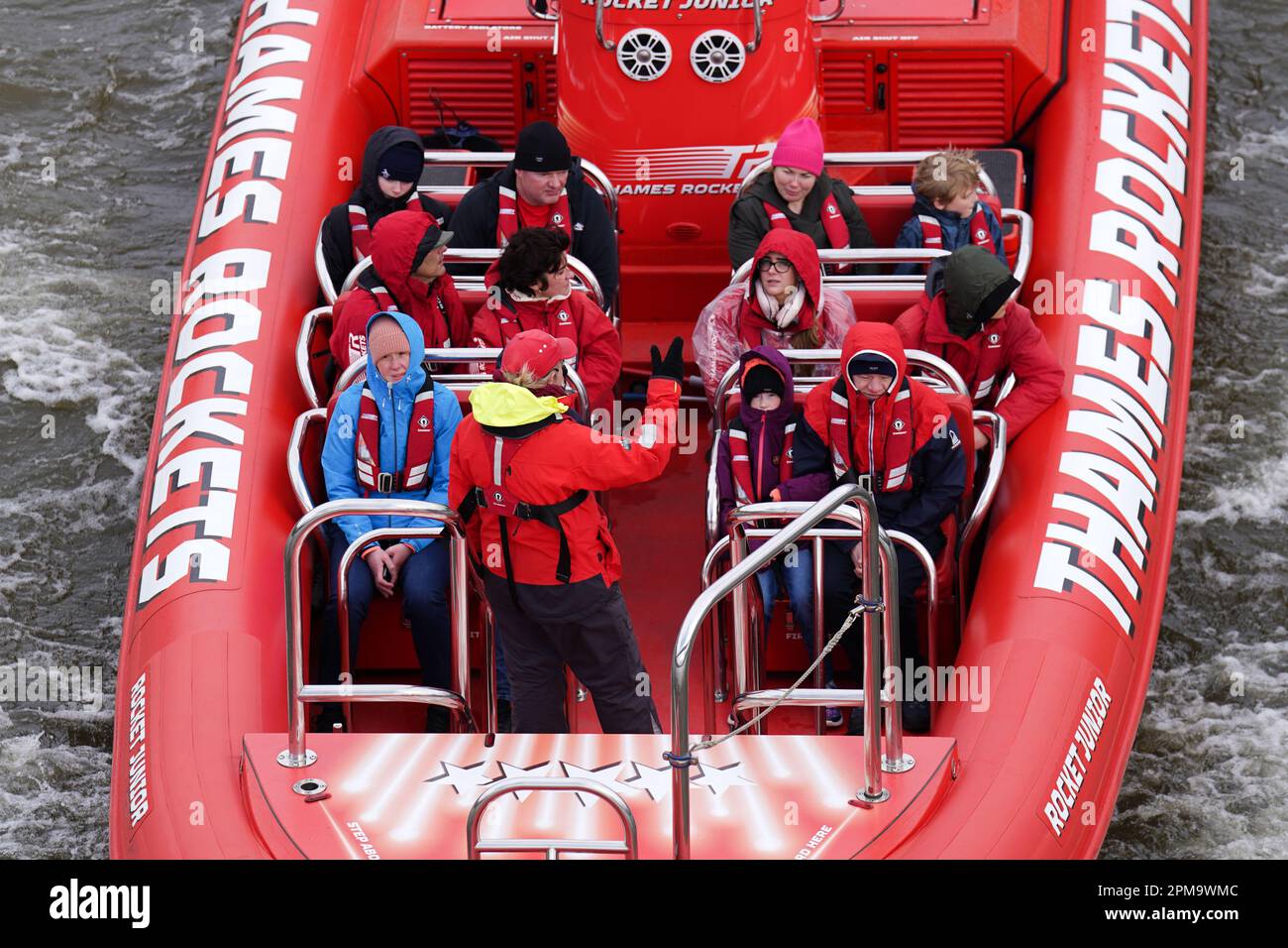 People on a boat near Millennium Bridge, London, as strong winds sweep ...