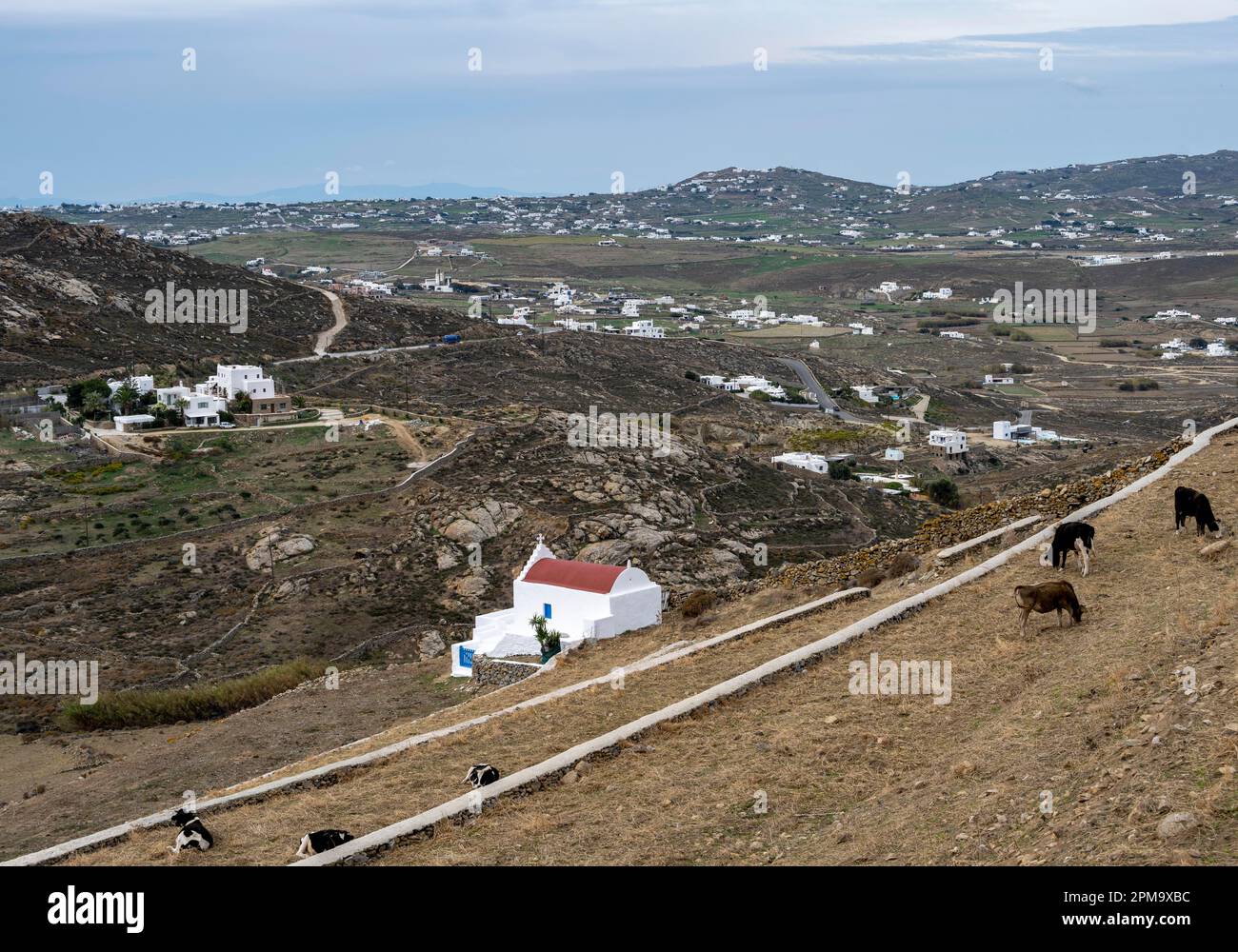 View over stony dry hills of Mykonos Island with small white and red ...
