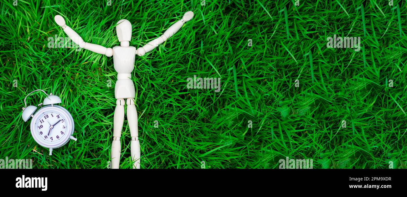 Time for rest, freedom concept. The figure of a man and an alarm clock ...