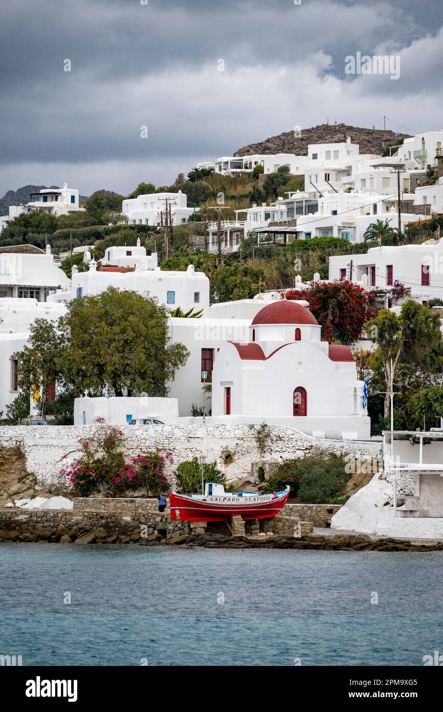 Fishing boat and small Greek Orthodox white church with red roof, Holy ...