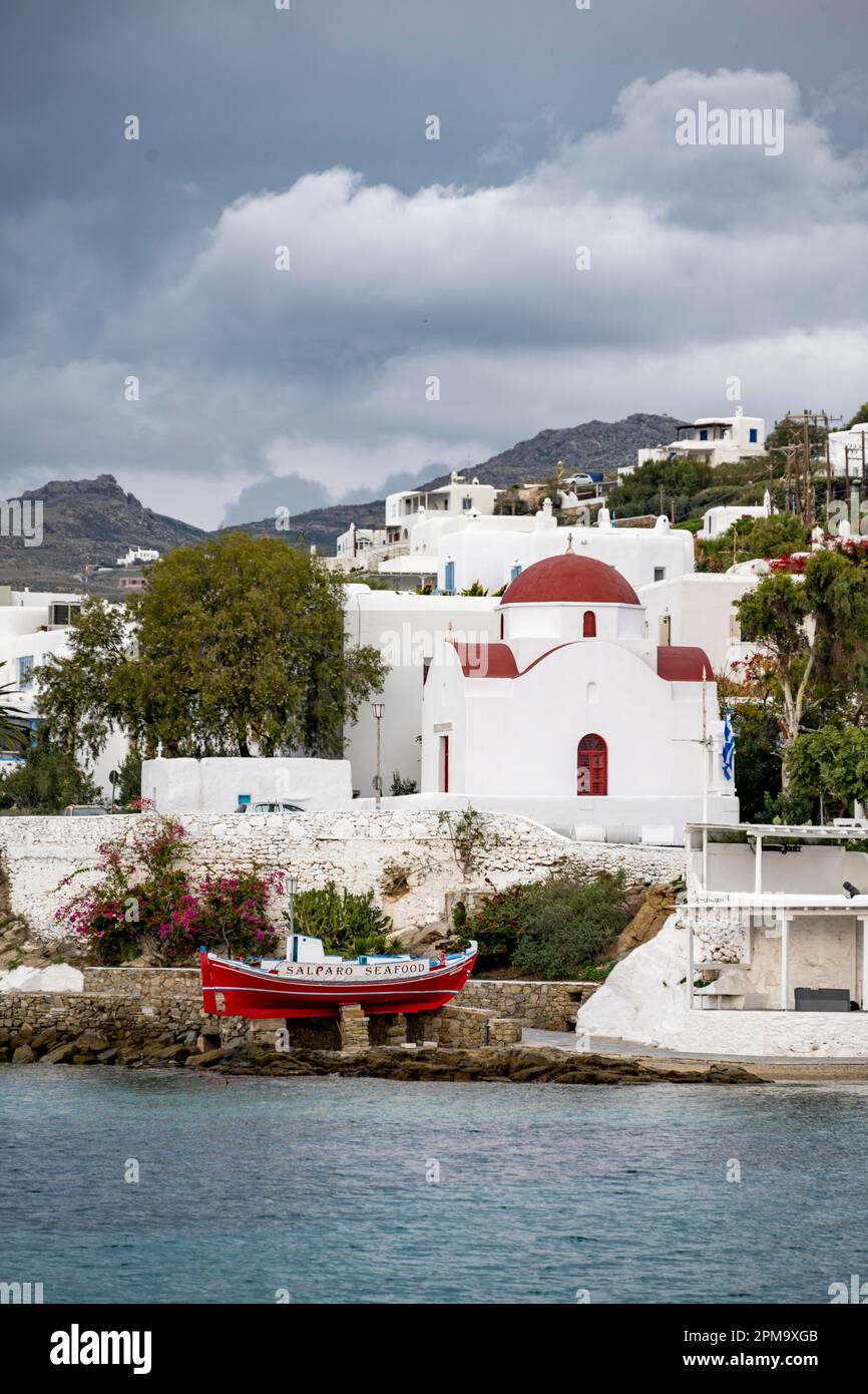 Fishing boat and small Greek Orthodox white church with red roof, Holy ...