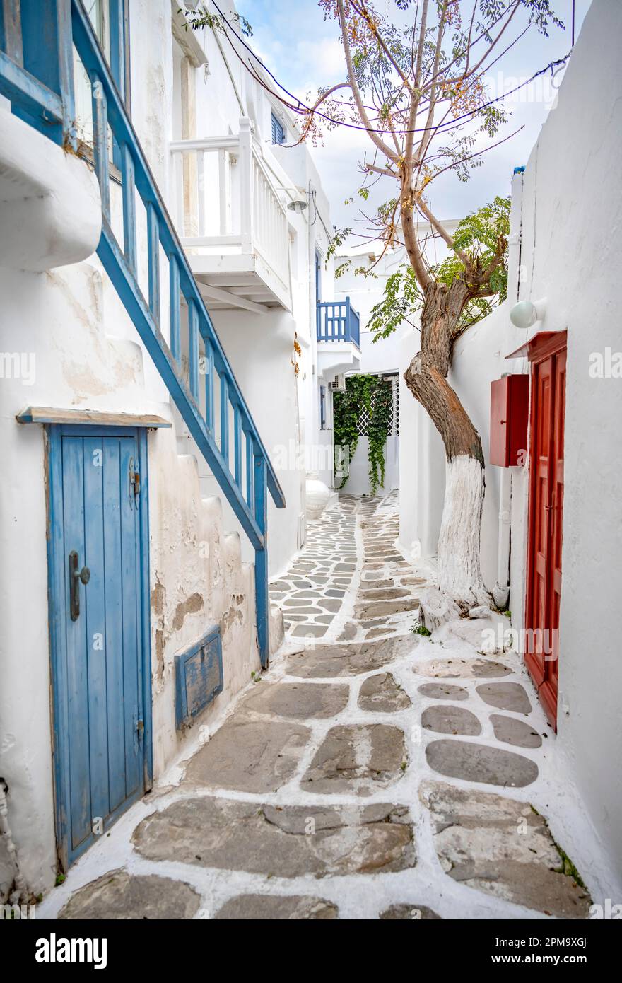Small alley with white Cycladic houses with colourful doors, Chora ...