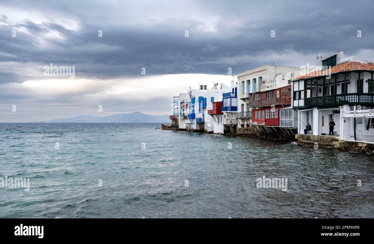 White Cycladic houses on the shore, Little Venice, dramatic dark clouds ...