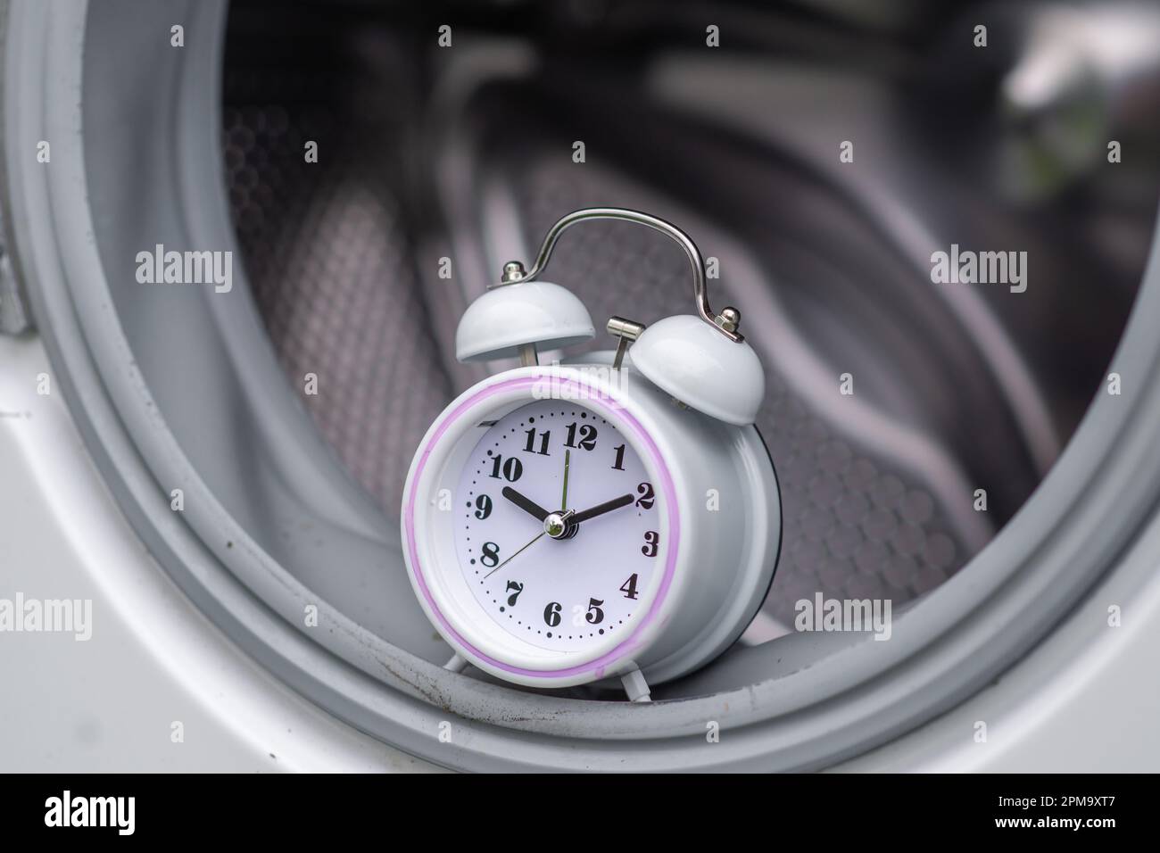 time and washing machine. Waiting, washing duration concept. Open door ...