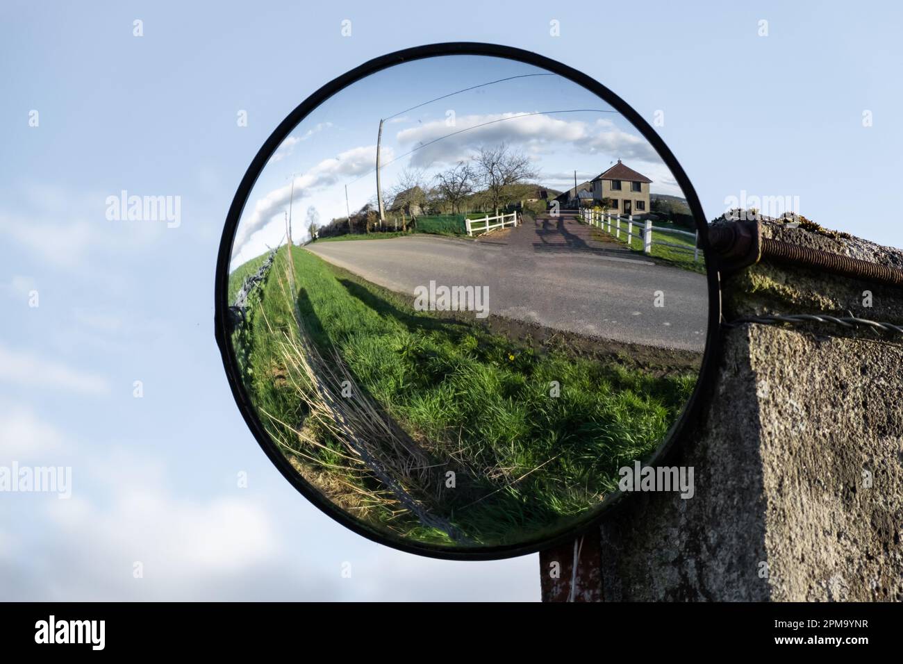 Round road mirror against the sky Stock Photo - Alamy