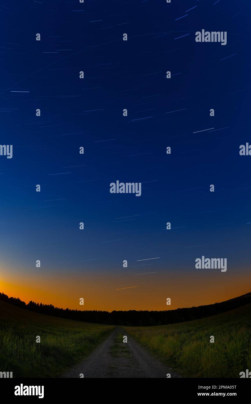 Field path under night sky Stock Photo - Alamy