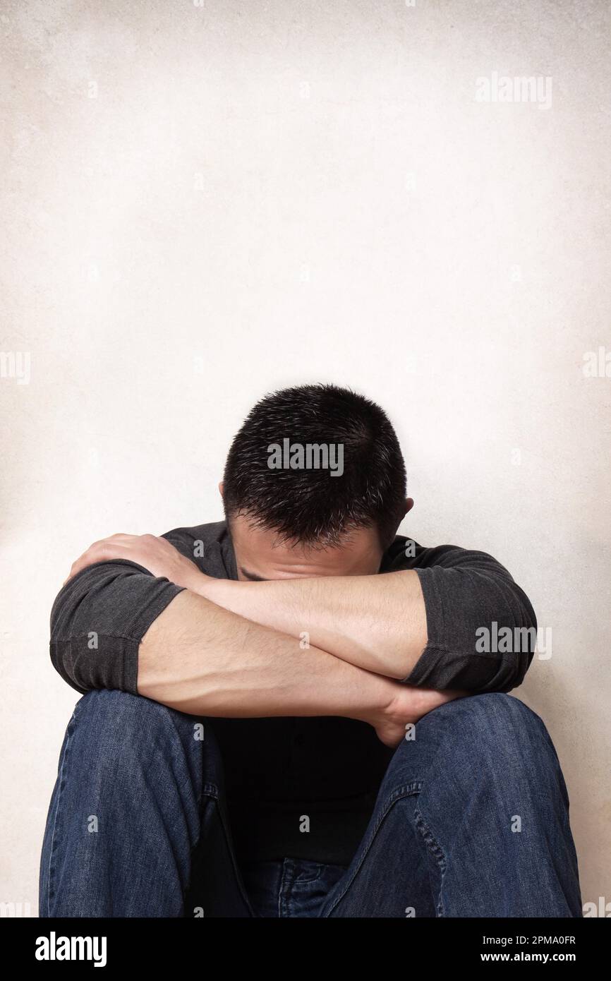depression sad young man hiding his face Stock Photo - Alamy