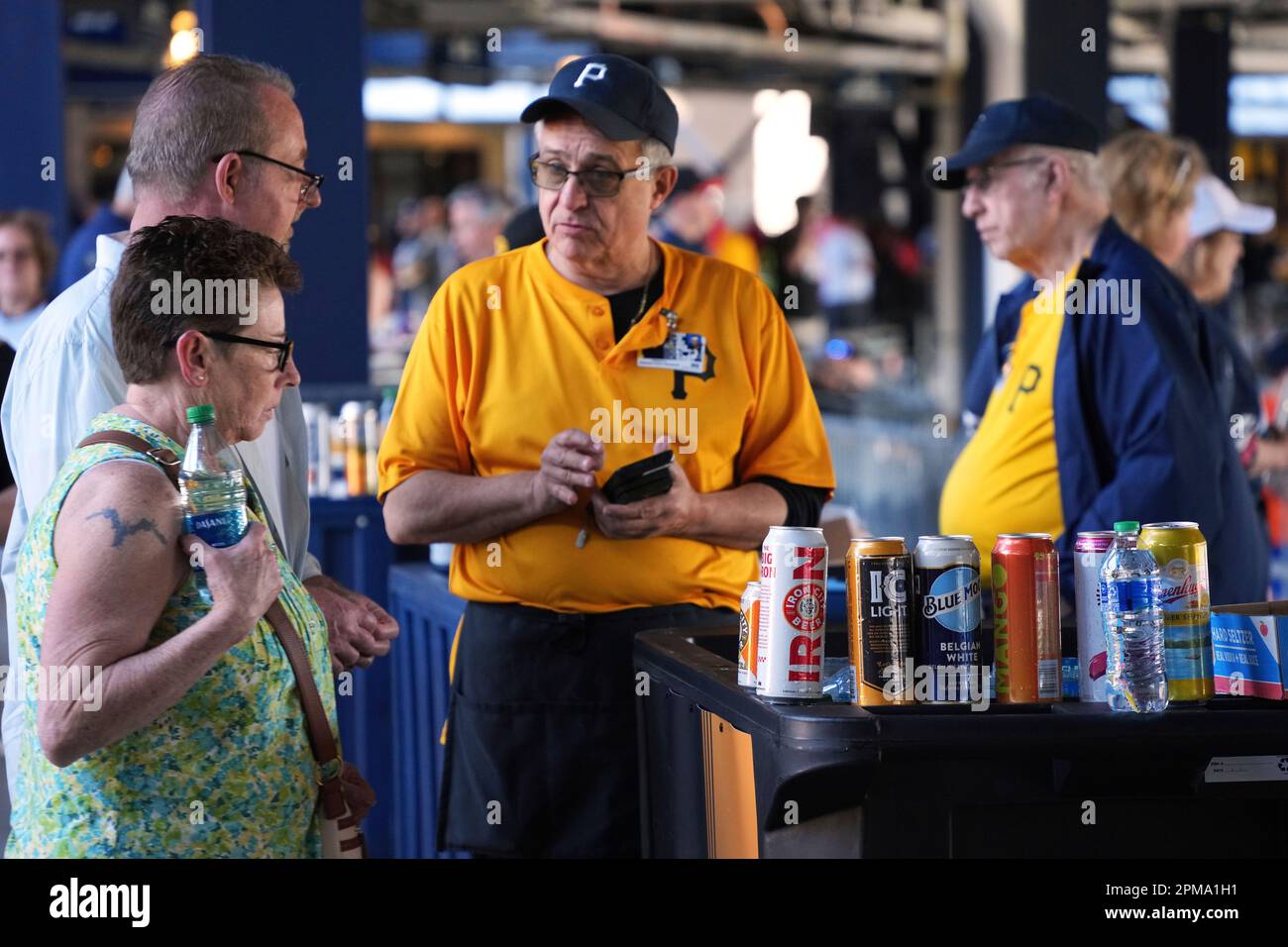 A vendor at PNC Park helps his customers before a baseball game between ...